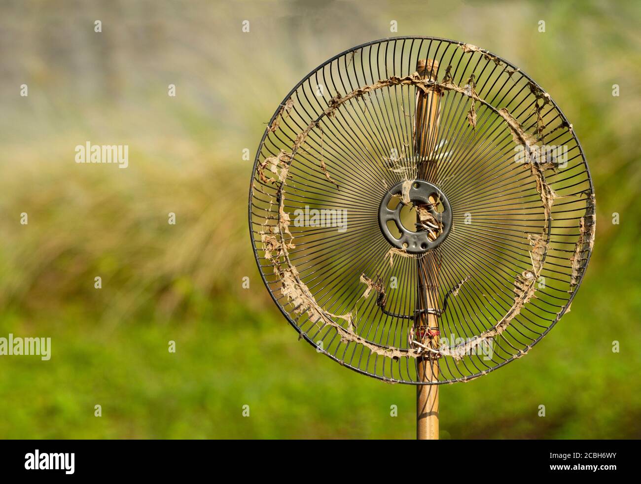 Recycle grating made from old fan cover attached with bamboo pole Stock ...