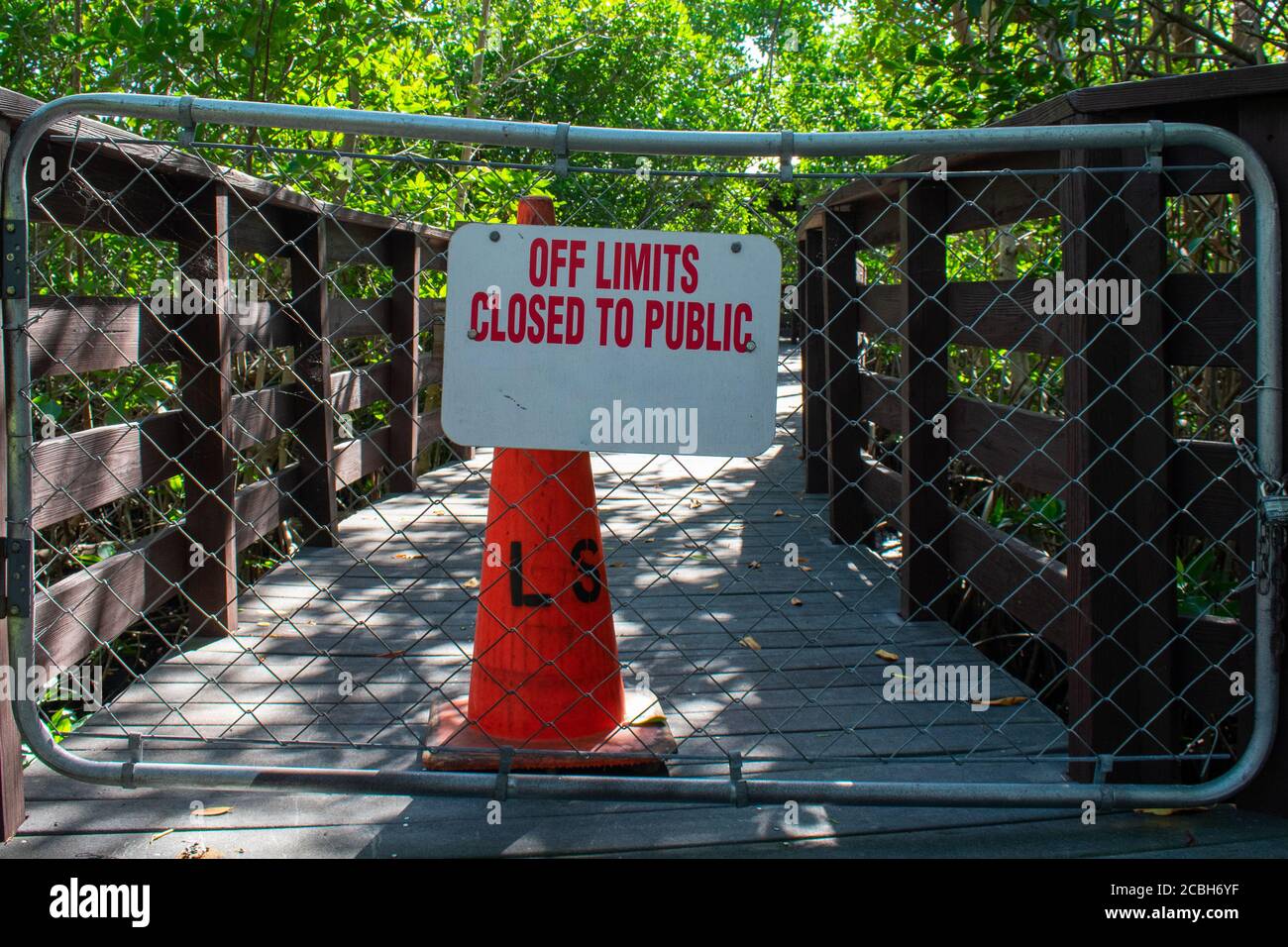 A Boardwalk With a Fenced Off Section With a Traffic Cone Behind It ...