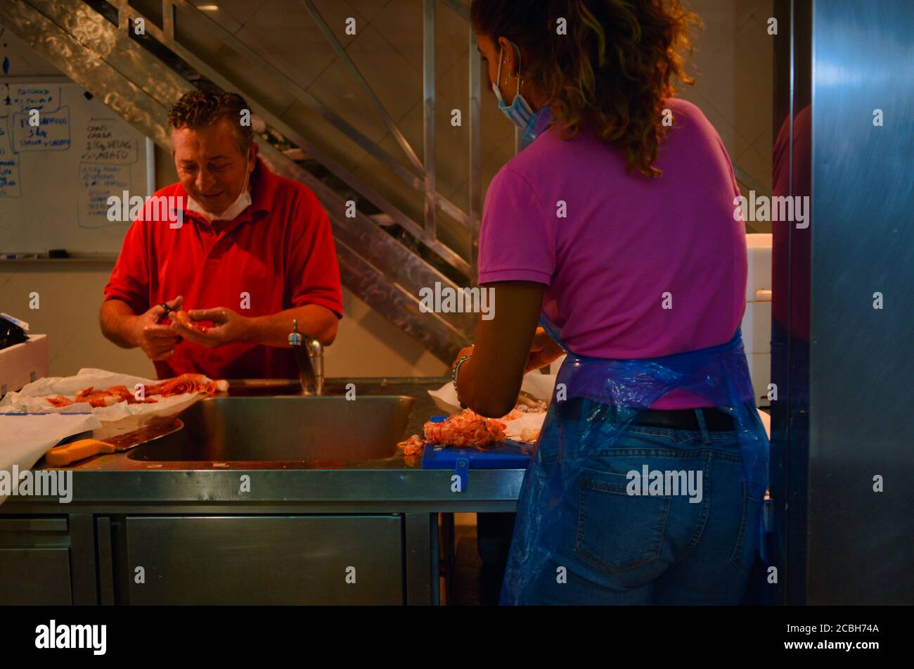 Italy - August 2020 at the fish market butcher works cleaning and ...