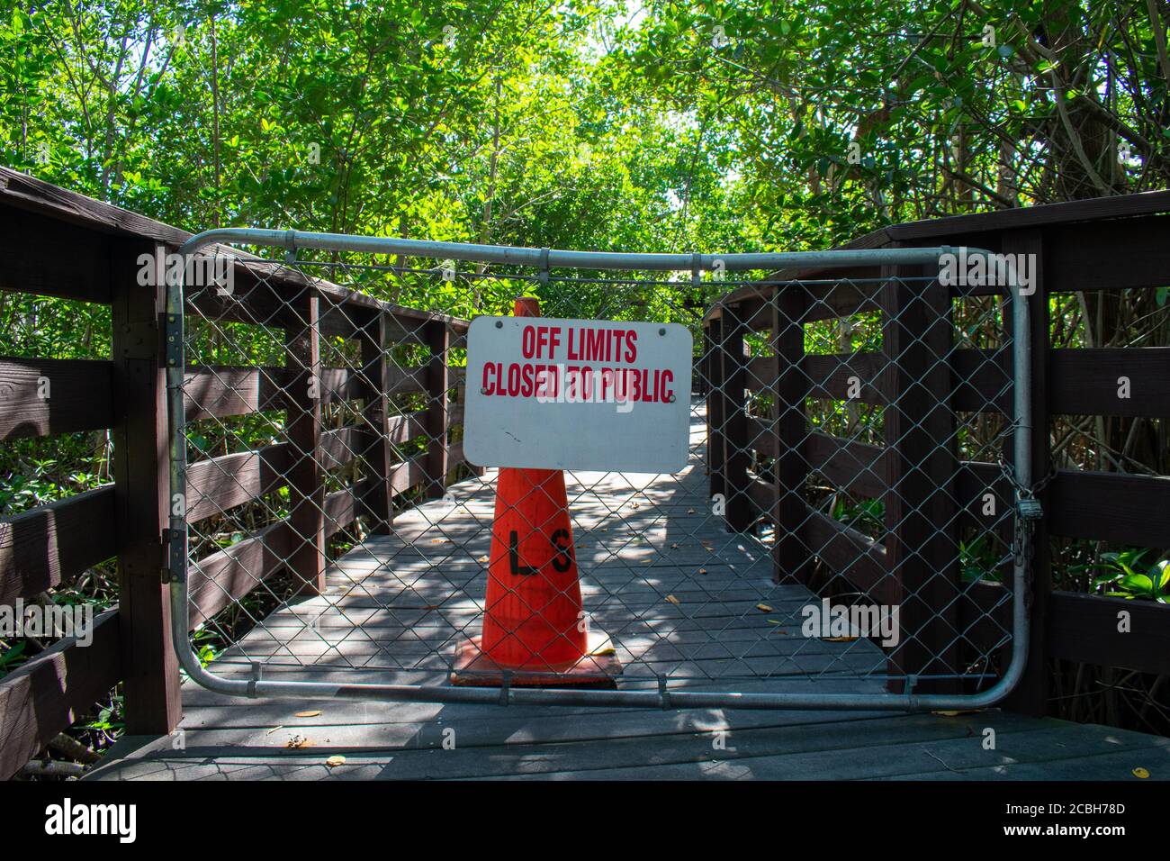 A Boardwalk With a Fenced Off Section With a Traffic Cone Behind It ...
