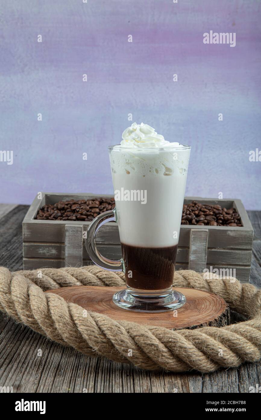 Caffe mocha with whipped cream. Latte macchiato in a tall glass. Glass ...