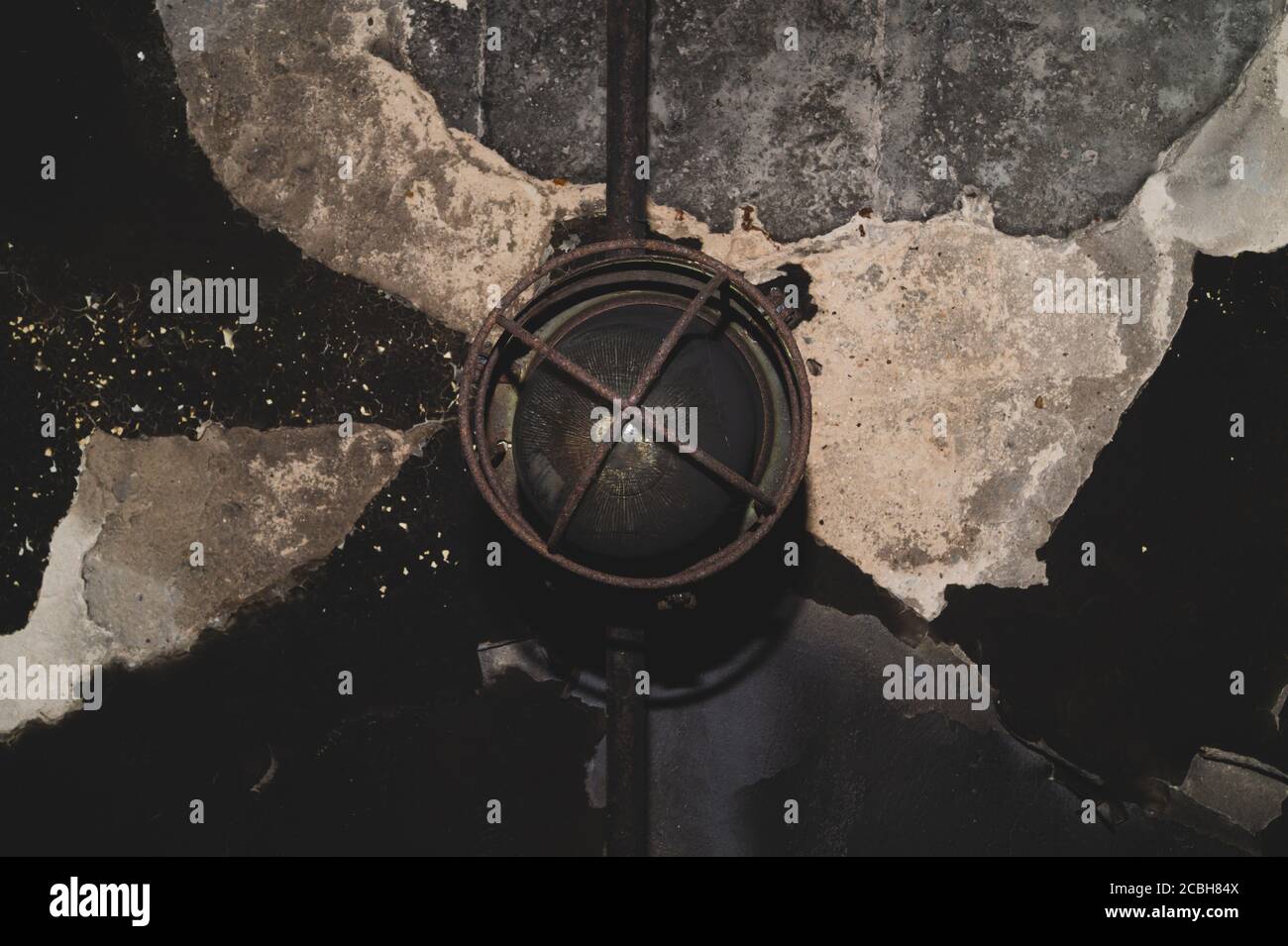 Lamp on an old ceiling in a ruined building. destroyed interior ...