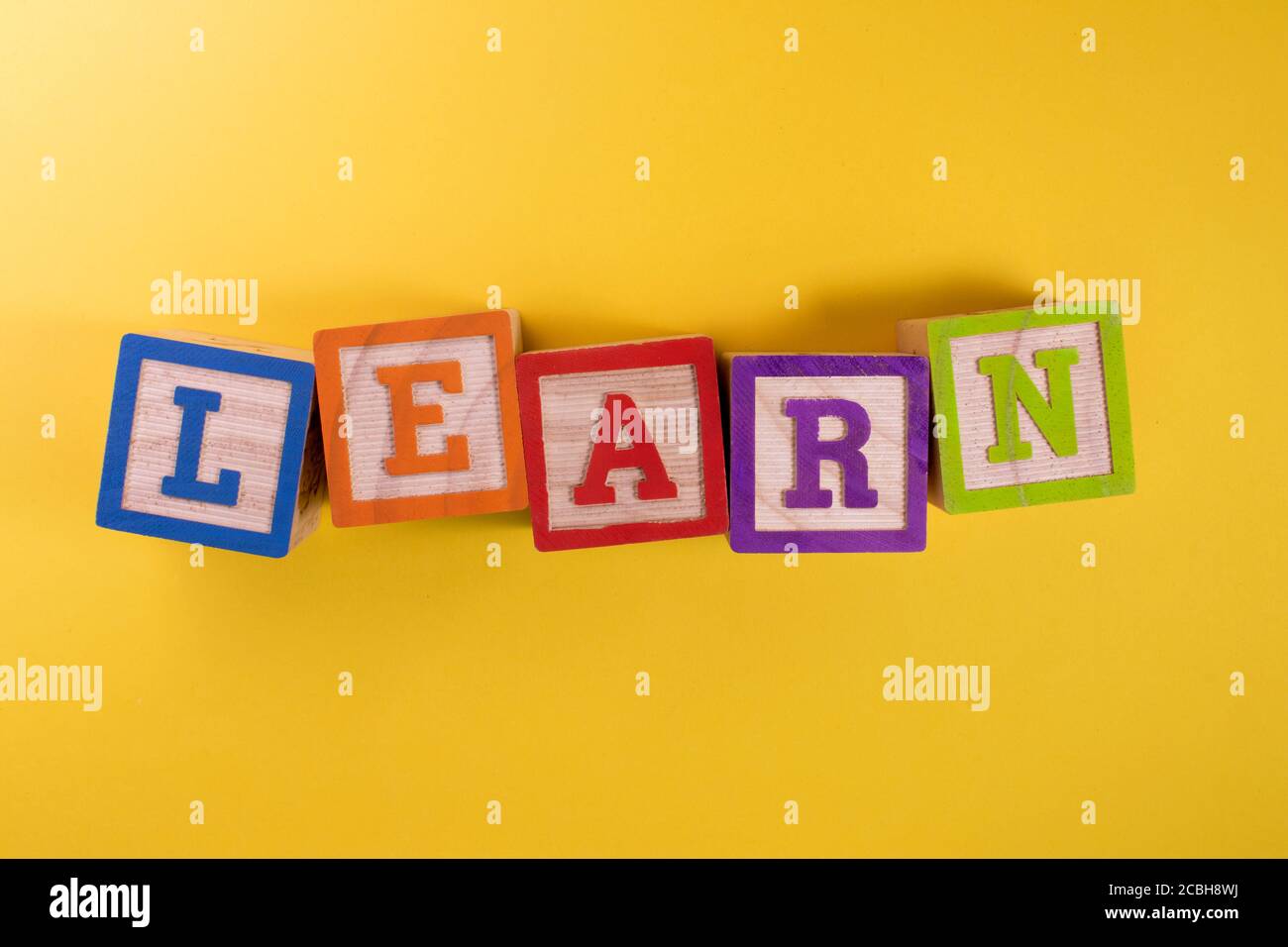 Word Learn written with wooden colored cubes Stock Photo - Alamy