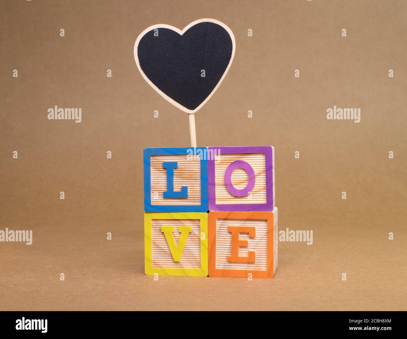 Love word made with wooden blocks and heart shaped chalkboard Stock ...