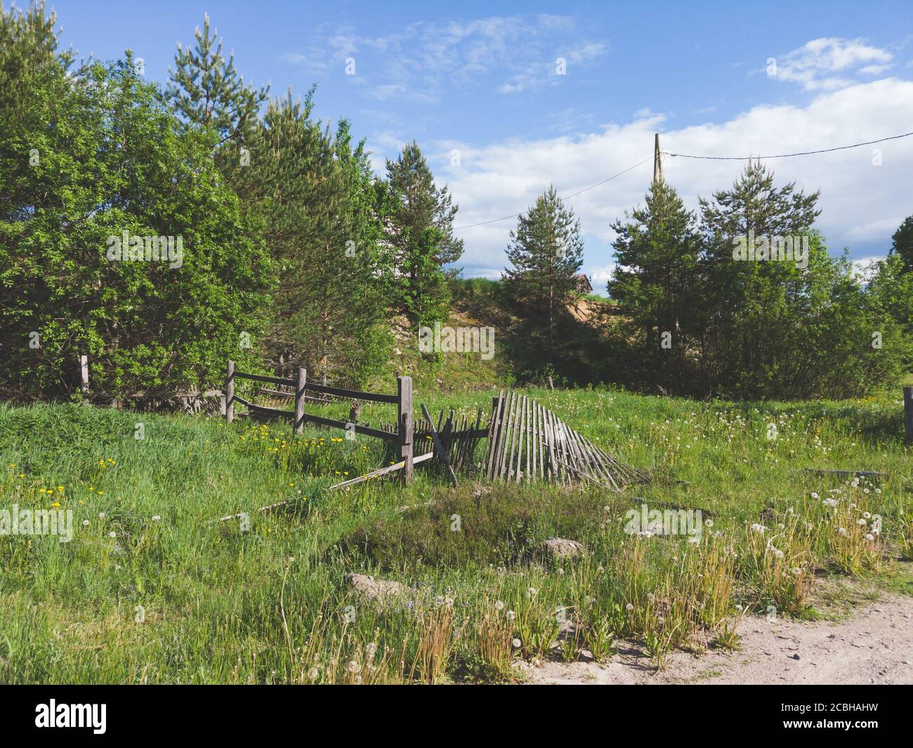 Destroyed wooden fence in countryside. rural landscape. summer day ...