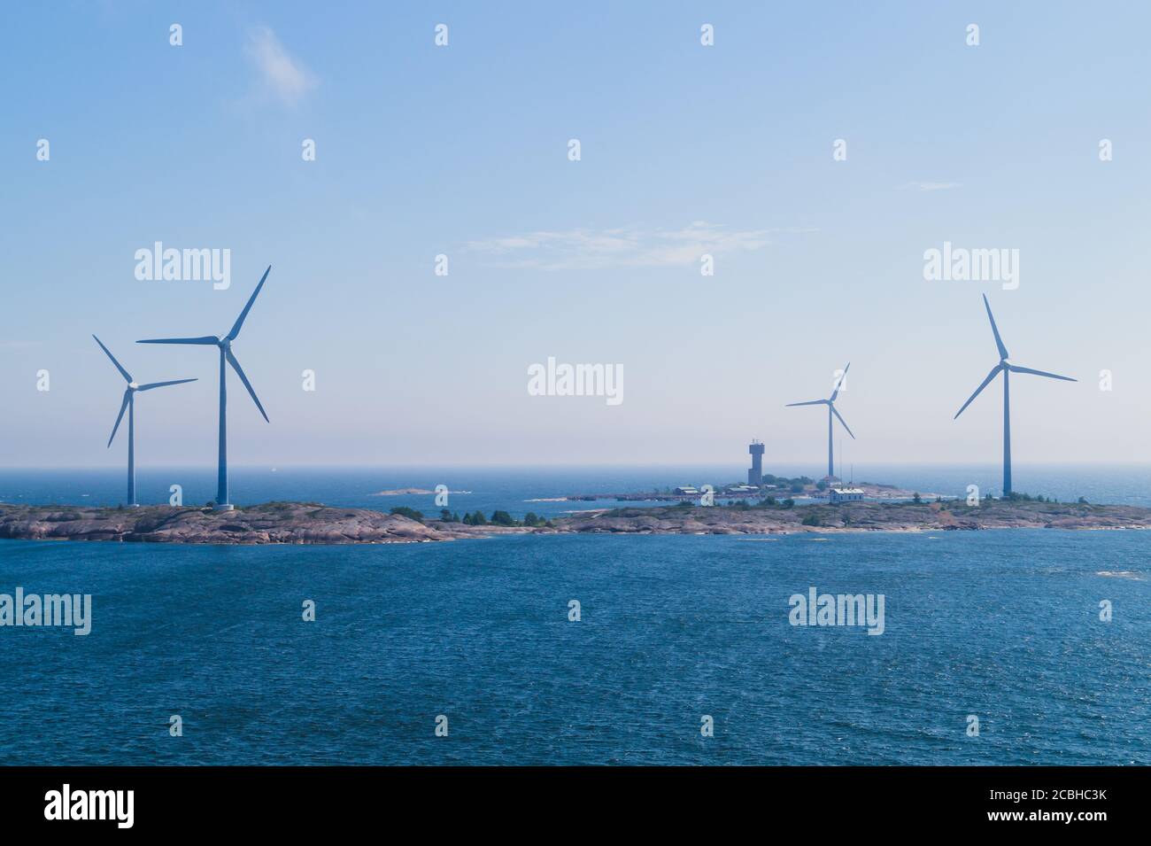 Windmill on an island in the sea. wind generator for generating ...