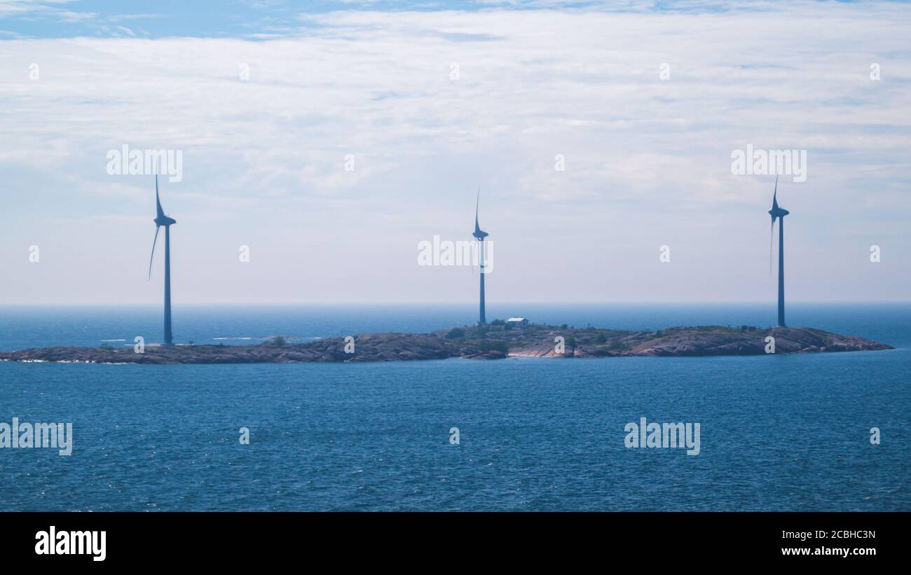 Windmill on an island in the sea. wind generator for generating ...