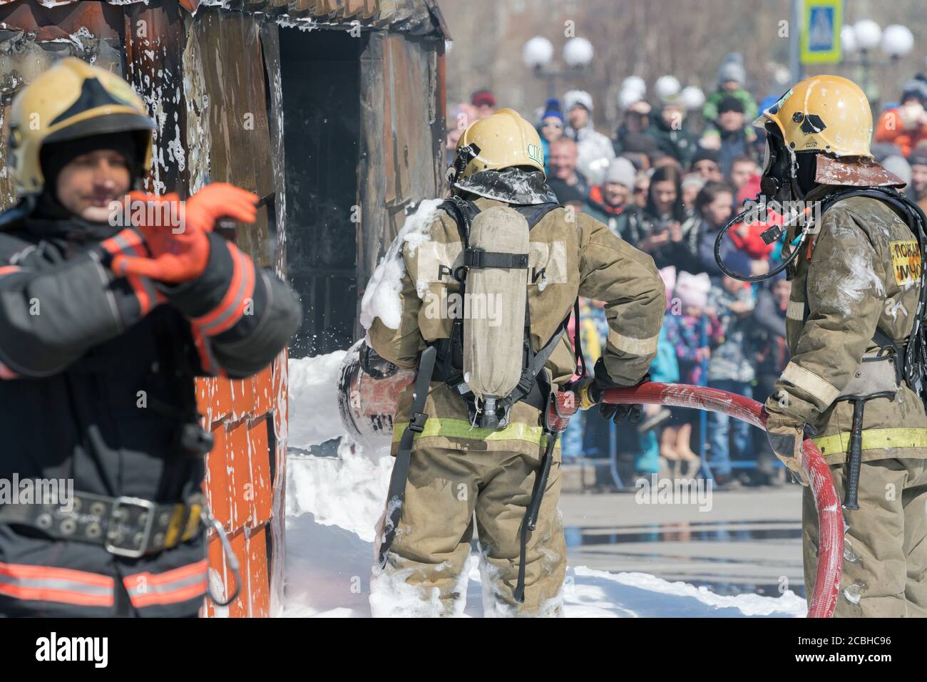 Group of firefighters extinguishing fire from fire hose, using ...