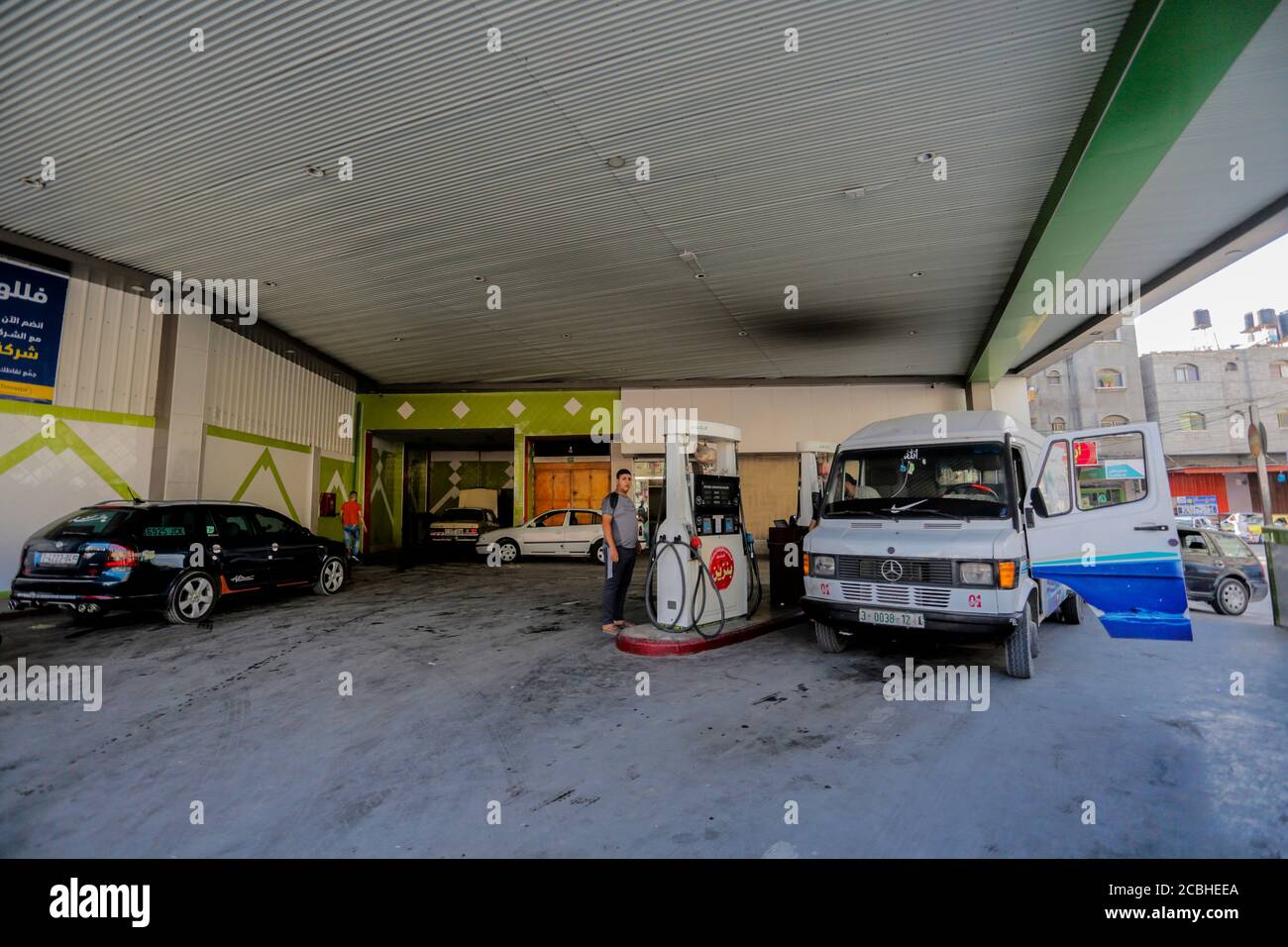 Gaza, Palestine. 13th Aug, 2020. A Palestinian employee refills the ...