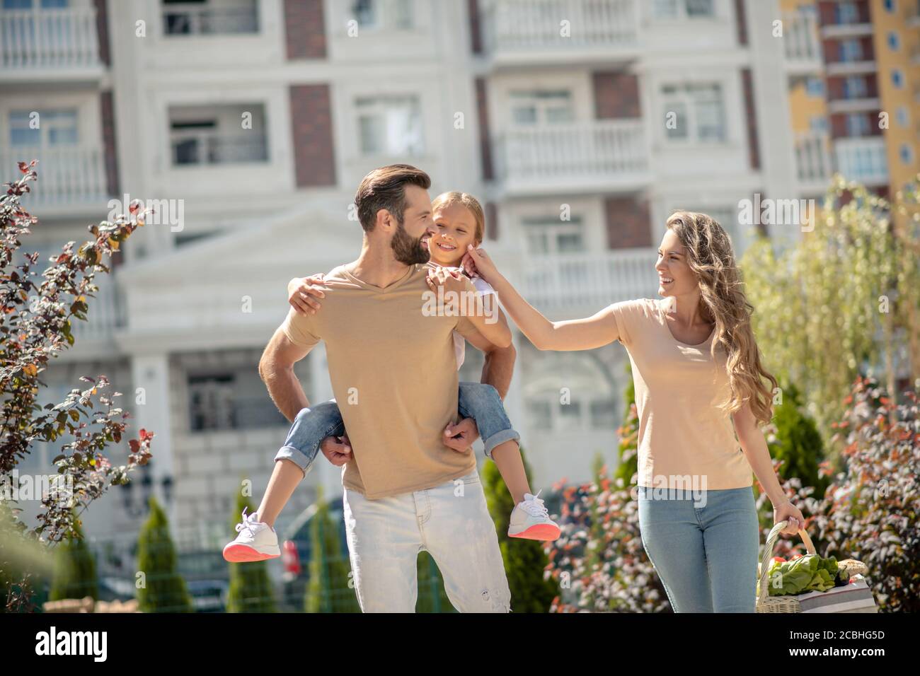 Cute family walking in the street and smiling happily Stock Photo - Alamy
