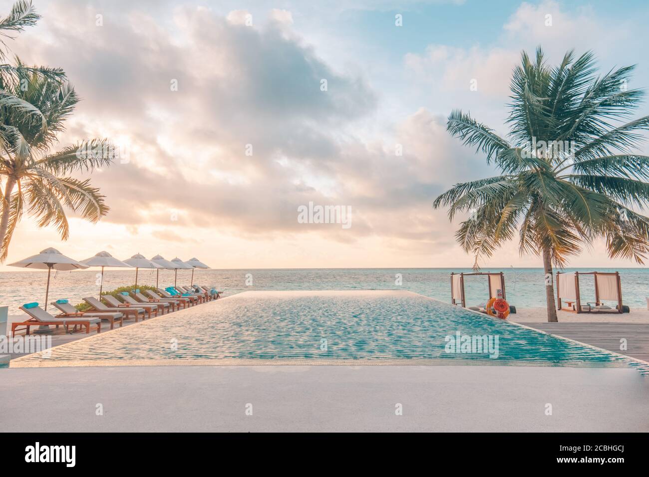 Tranquil poolside setting sunset hi-res stock photography and images ...
