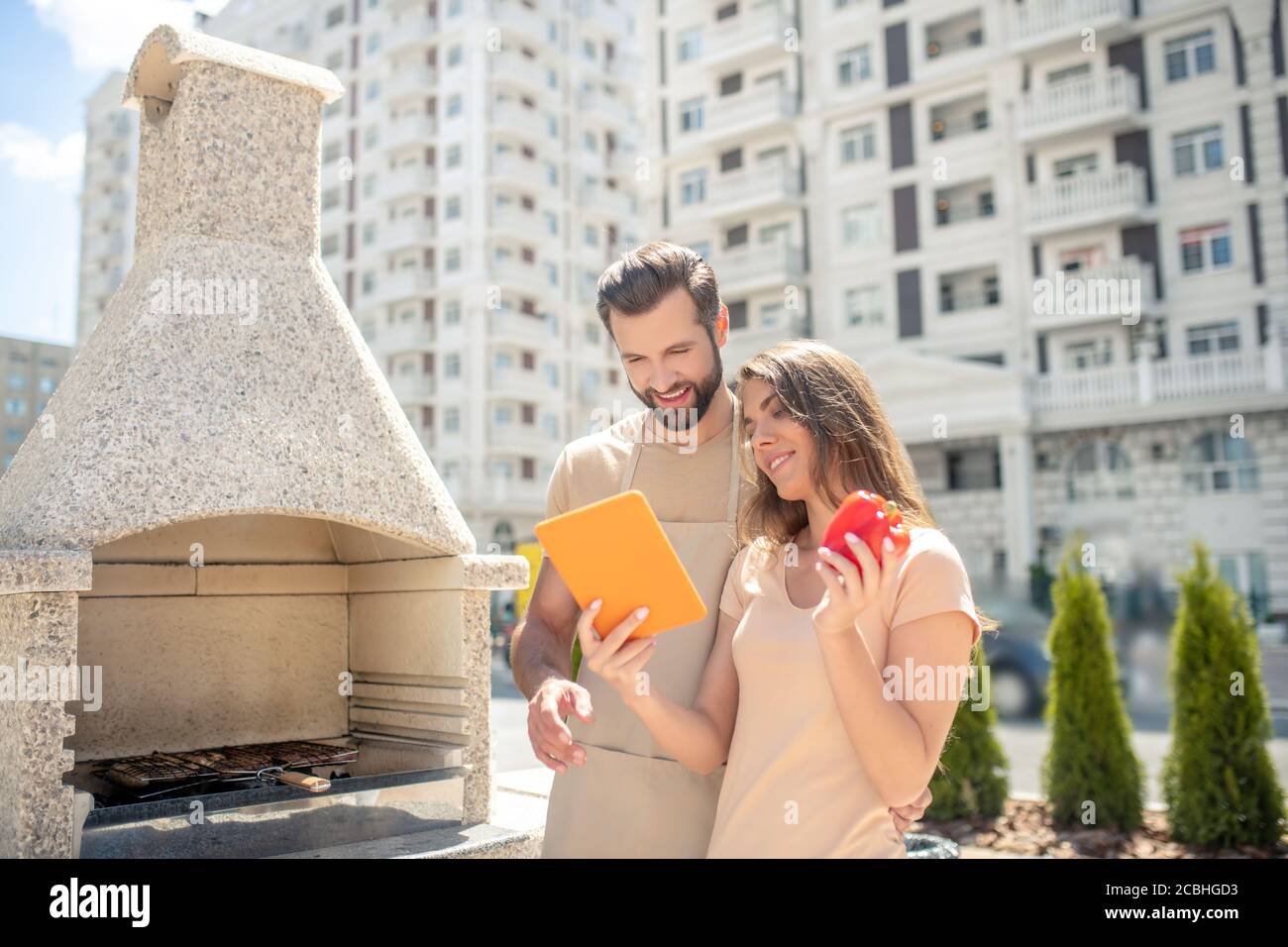 Young couple watching something on internet and smiling Stock Photo - Alamy