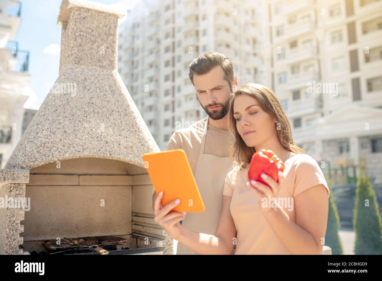 Young couple standing and watching something on internet Stock Photo ...
