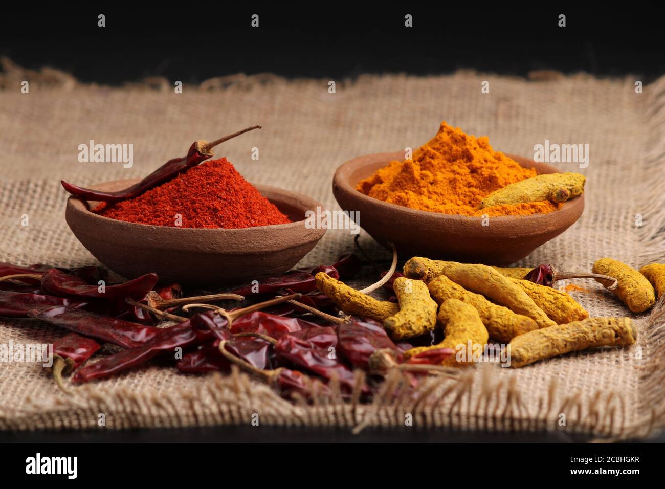 Indian spices Chilli and turmeric powder in a clay pot with red ...
