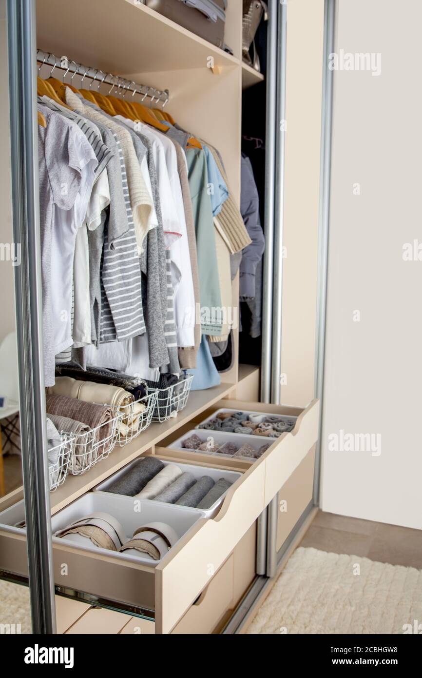 Wardrobe with perfect order clothes shades. Storage clothes Stock Photo ...