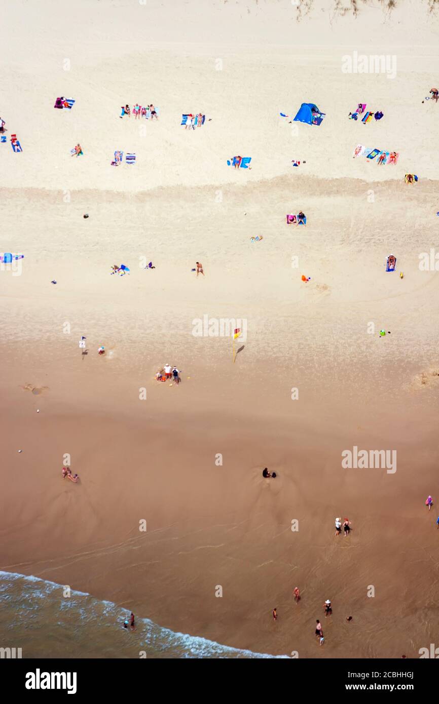 Drone shot of sandy beach with people Stock Photo - Alamy