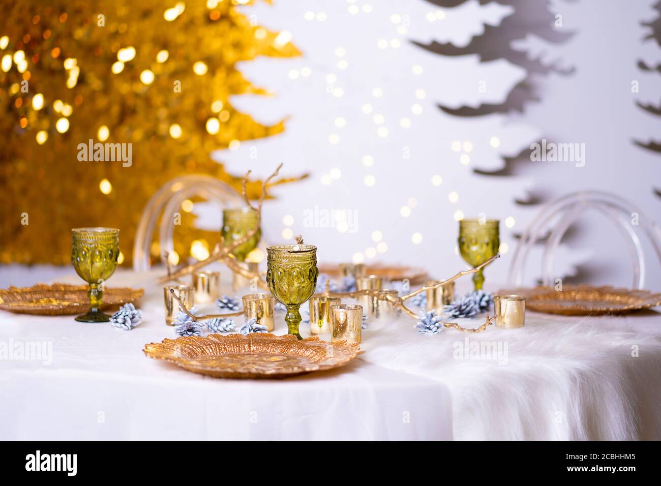 The festive Christmas table is decorated with branches of a Christmas ...