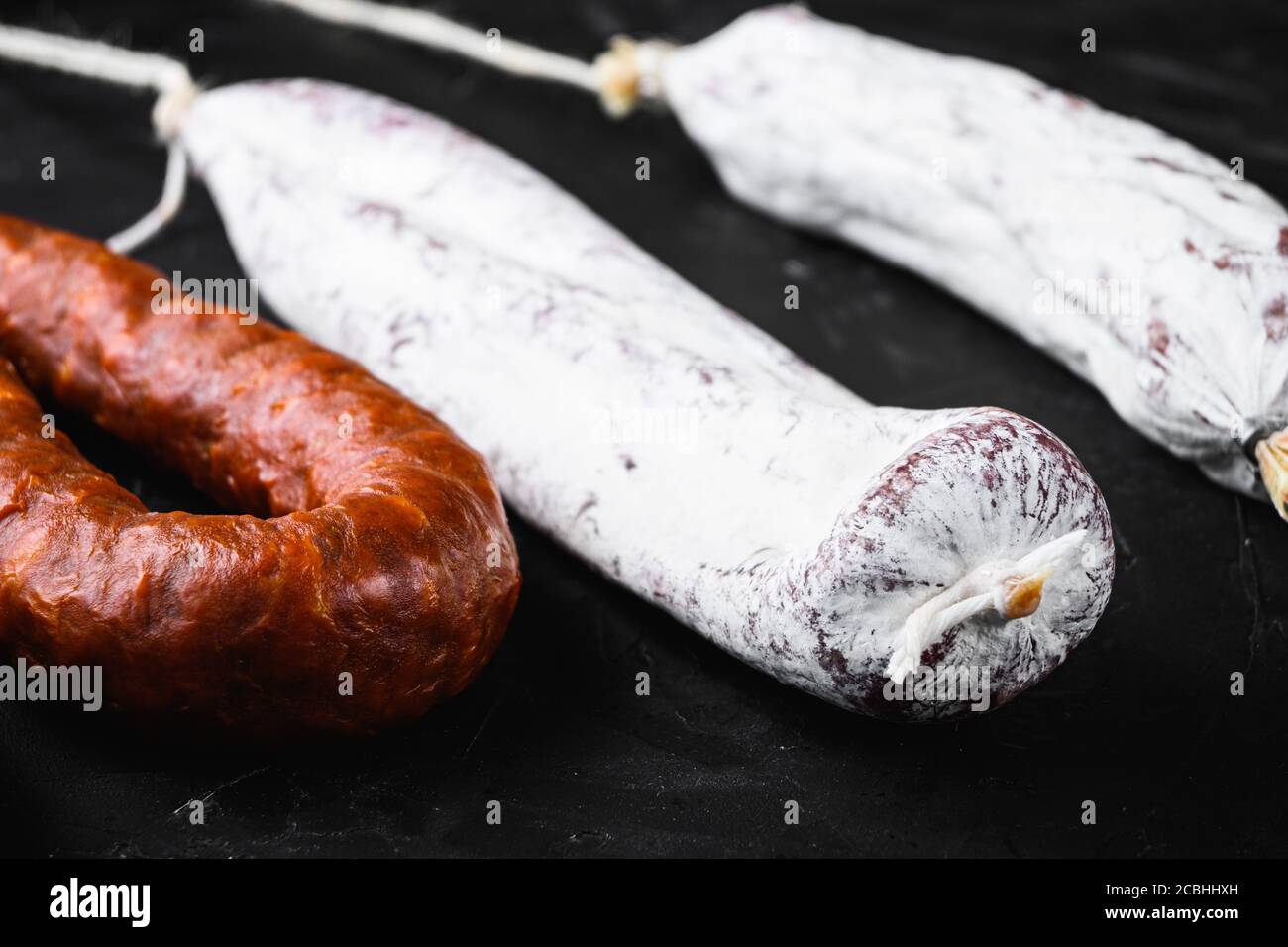 Traditional spanish sausages fuet and chorizo on black surface Stock ...