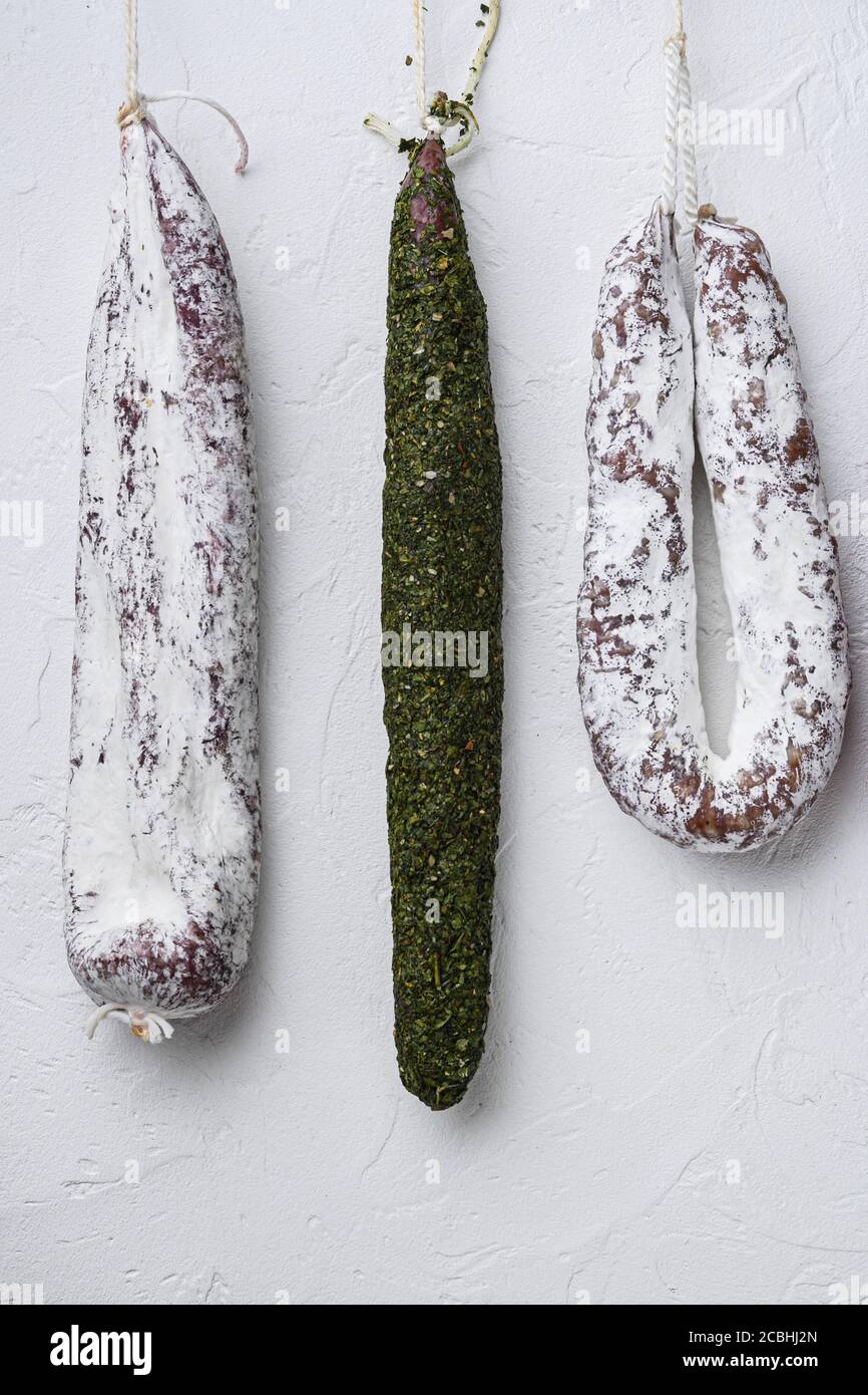 Traditional dry cured sausages meat hanging on white background Stock ...