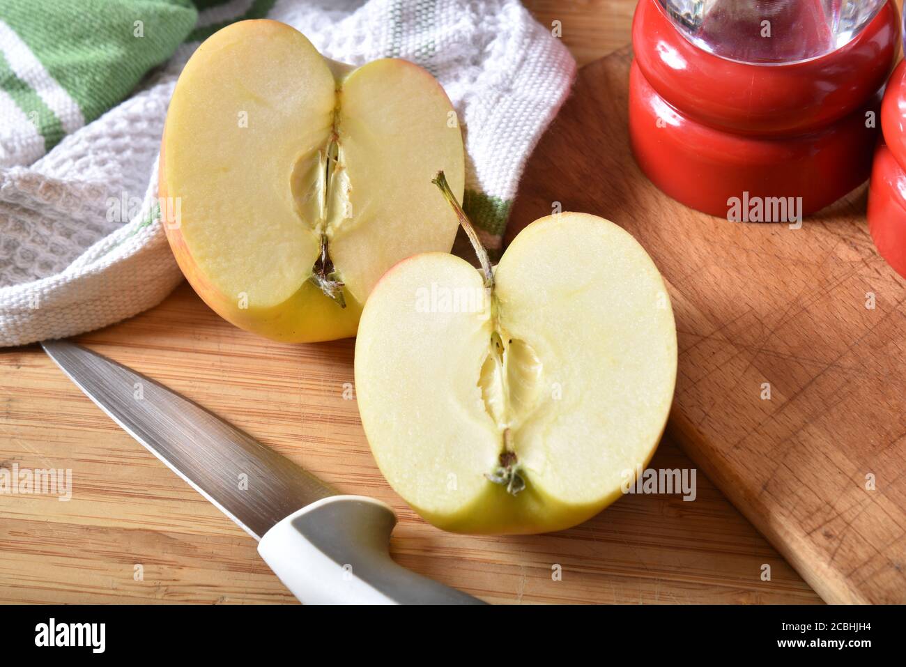A sliced organic Fuji apple on a cutting board Stock Photo - Alamy