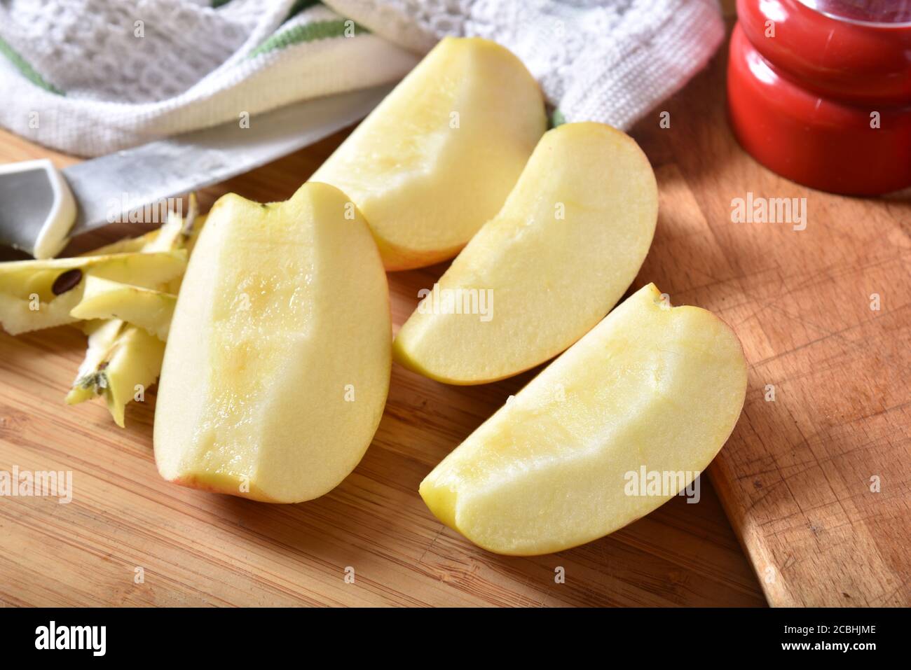 A fuji apple sliced into wedges on a cutting board Stock Photo - Alamy