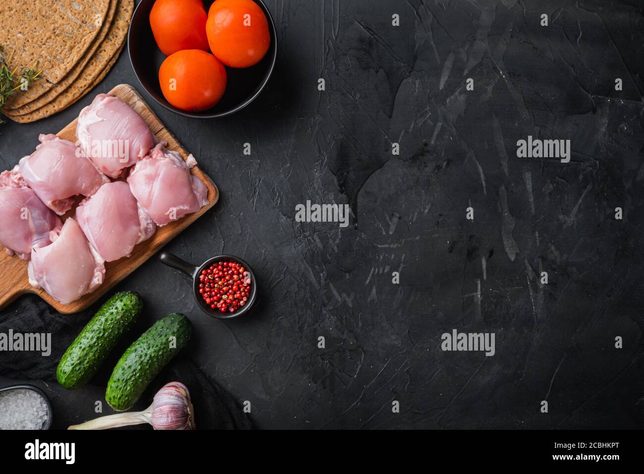 Shawarma ingredients, chicken meat on black background, flat lay with ...