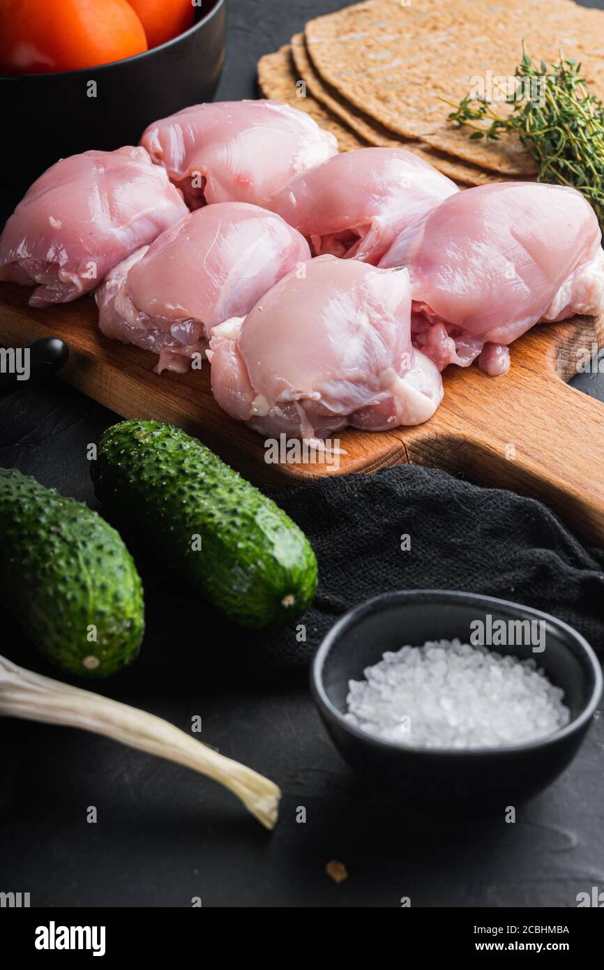 Shawarma ingredients, chicken thigh on black background Stock Photo - Alamy