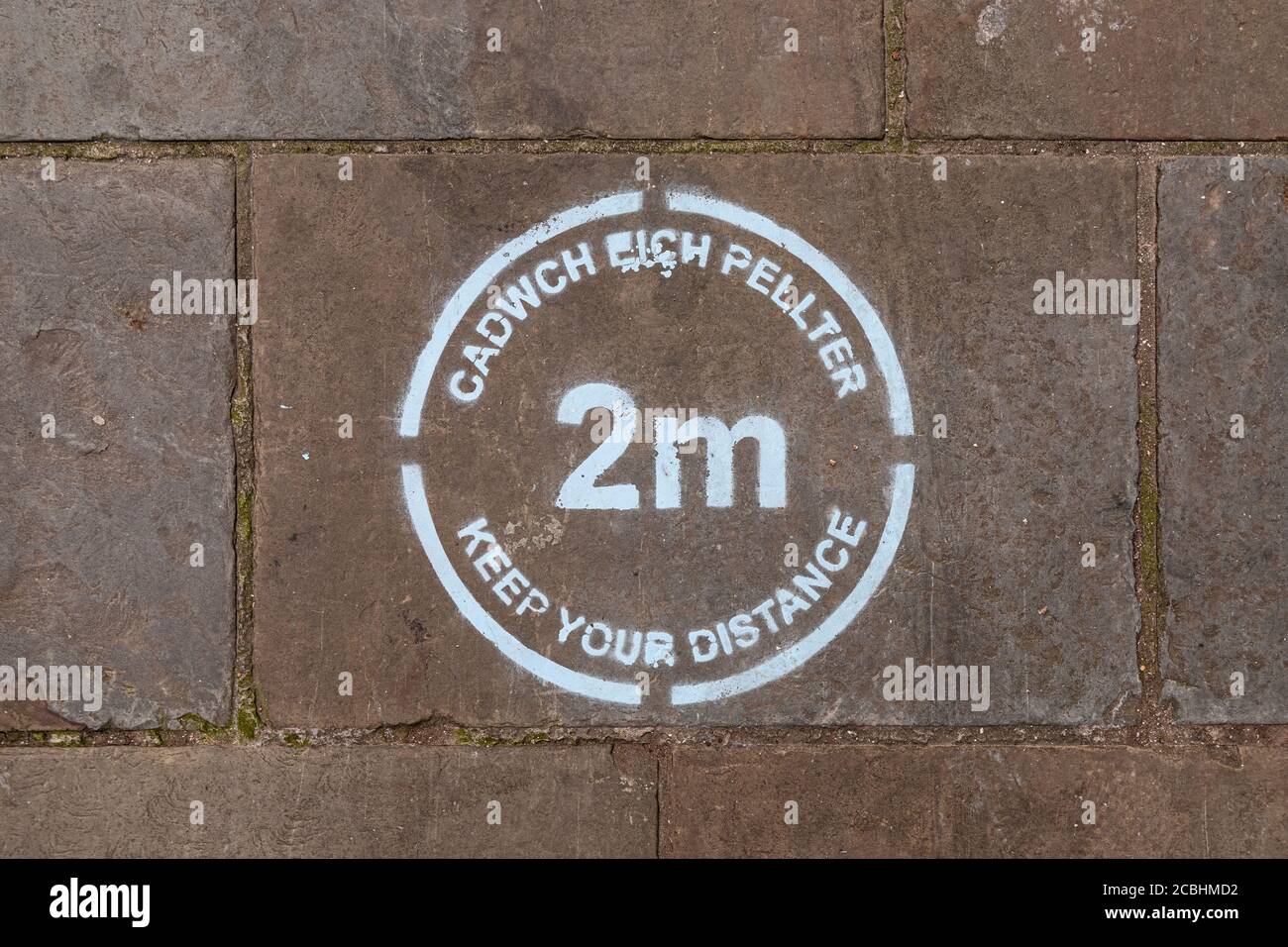 Social distancing sign on pavement in Caernarfon, North Wales Stock ...