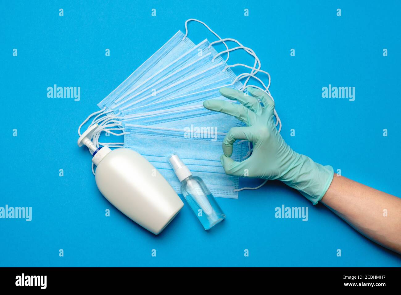Human hand in protective glove, face protective masks and hand ...