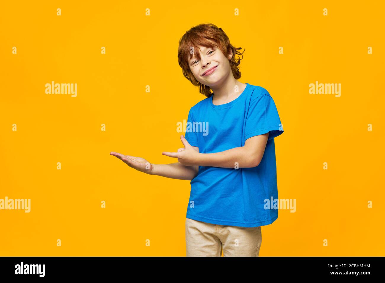 red-haired child freckles show with hands to the side and smirk on the ...