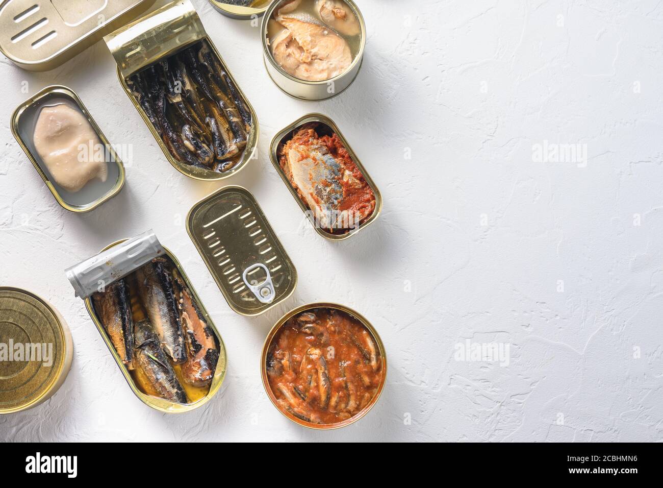 opened cans with different types of fish and seafood, opened and closed ...