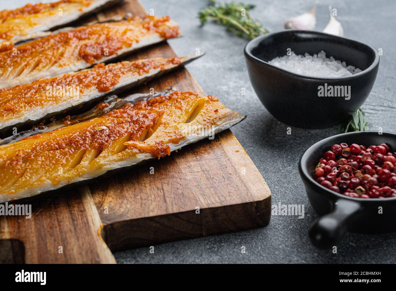 Marinated scomber fillet with paprika and saffron on grey background ...