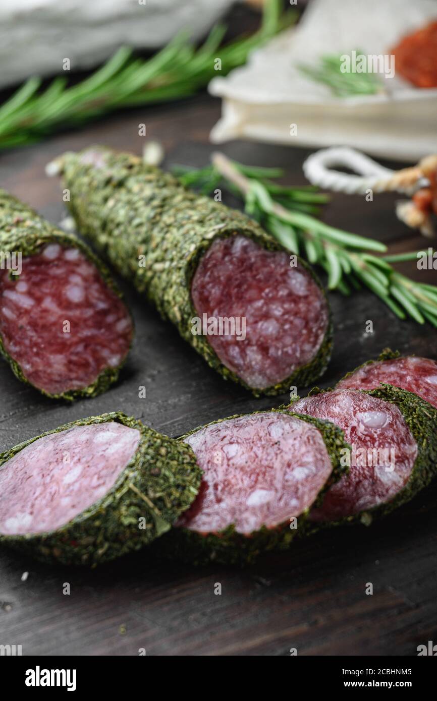 Variety of dry cured chorizo, fuet and other sausages cut in slices ...