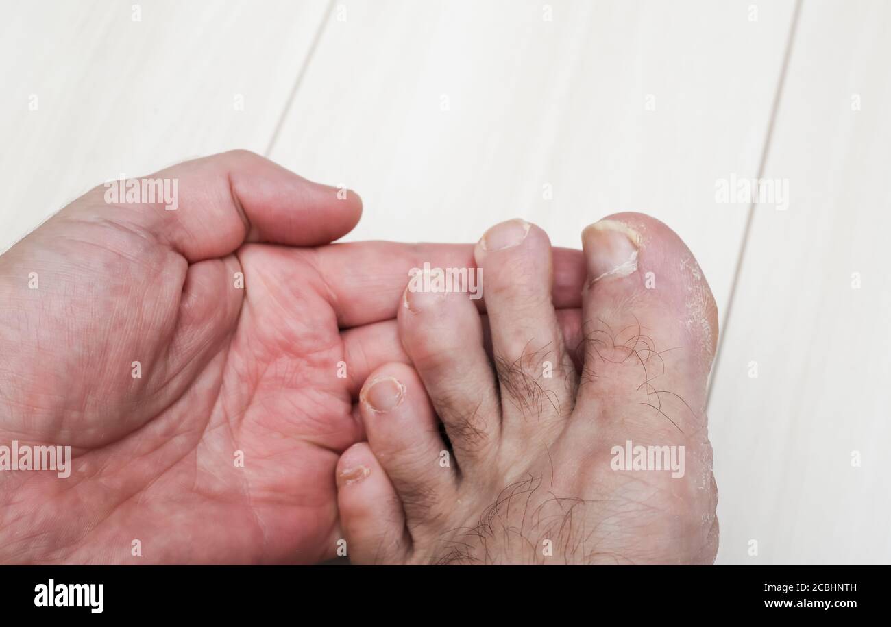 Man lifting foot hi-res stock photography and images - Alamy