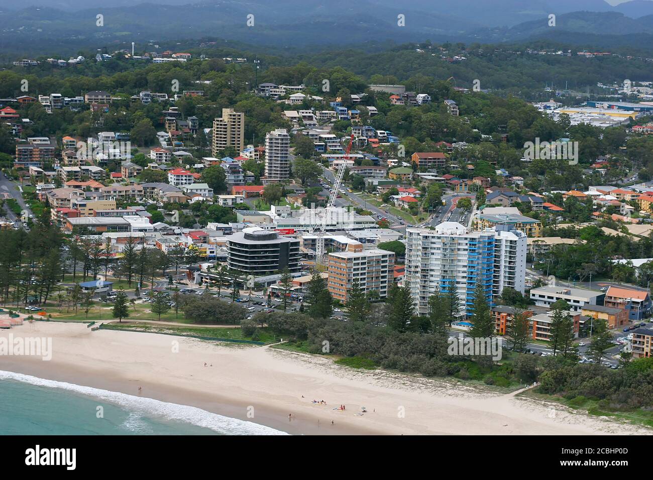 Empty beach in front of a city Stock Photo - Alamy