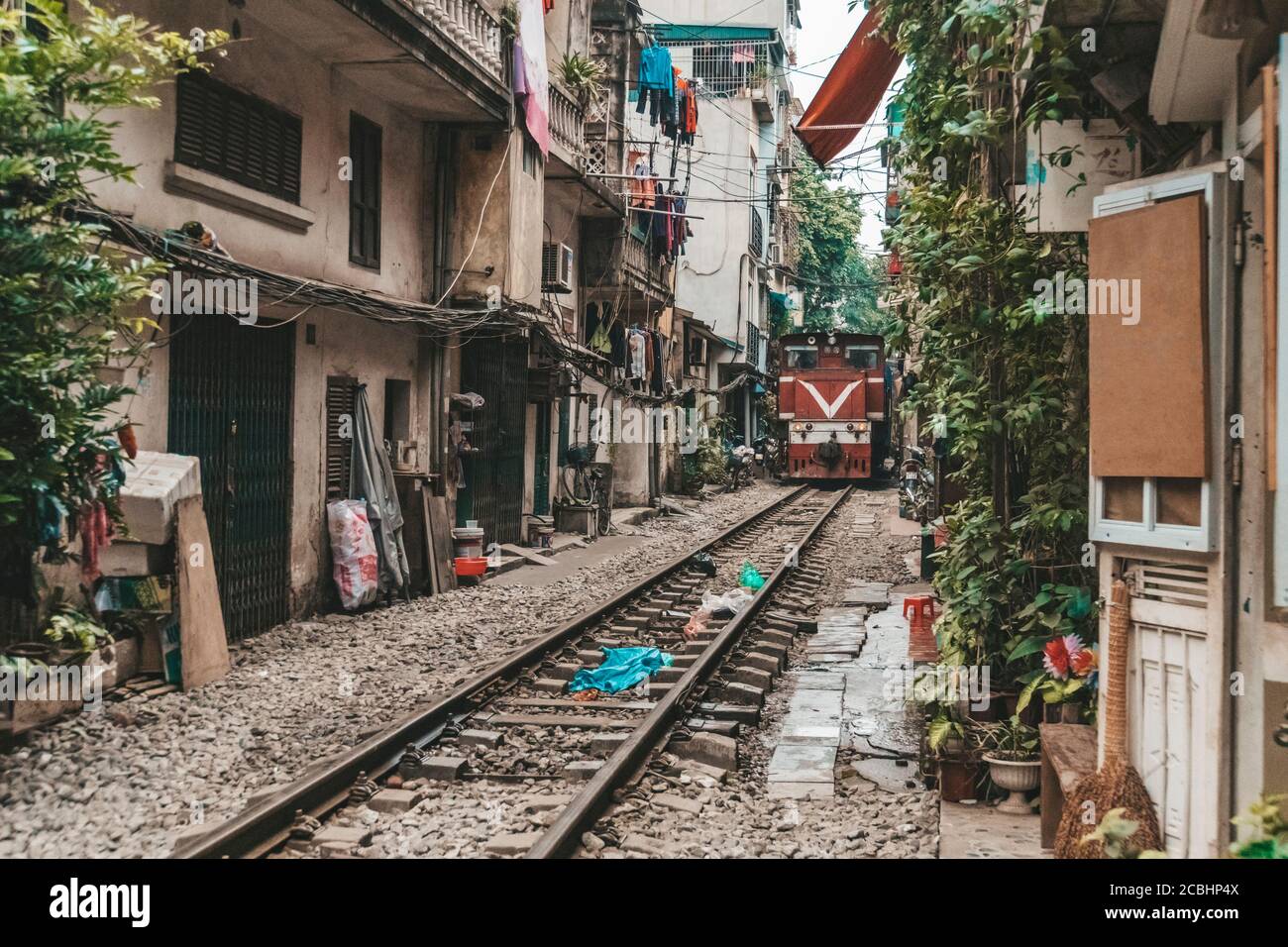 A train run through an ancient town in Hanoi Stock Photo - Alamy