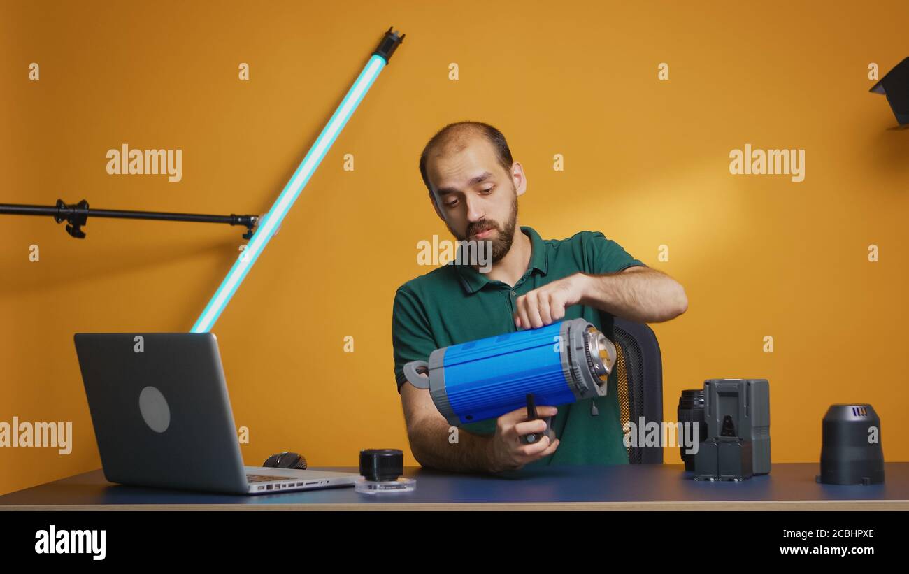 Videographer recording tutorial about new cinema light in studio ...