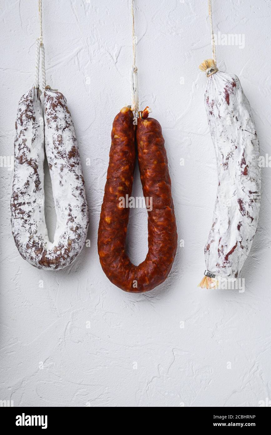 Traditional dry cured sausages meat hanging on white background Stock ...
