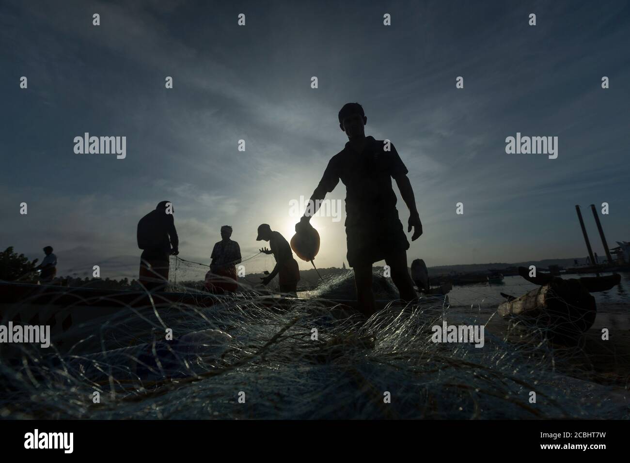 Fishermen fixing their nets before going into deep sea Stock Photo - Alamy
