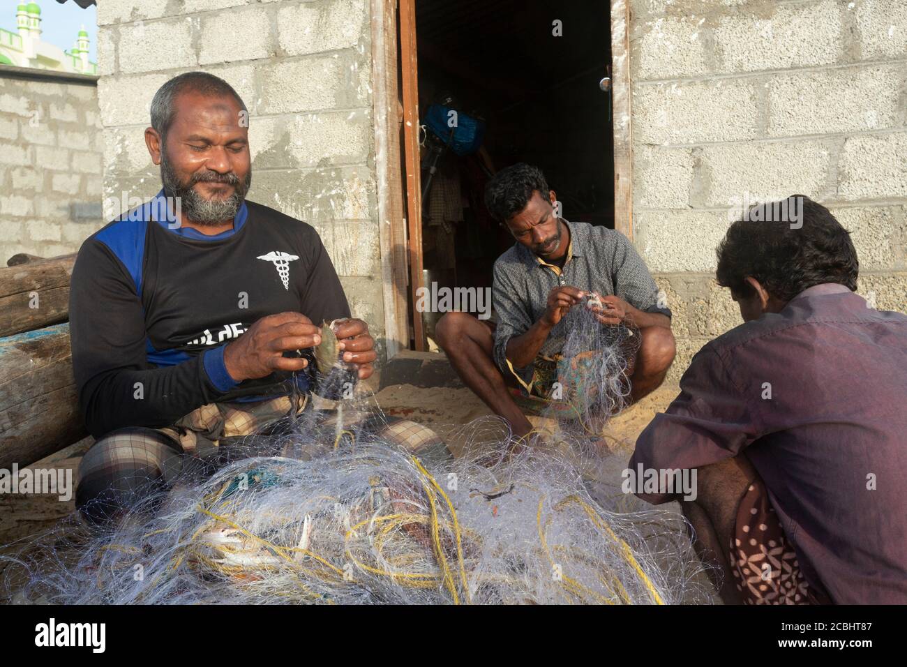 Fishermen fixing their nets before going into deep sea Stock Photo - Alamy