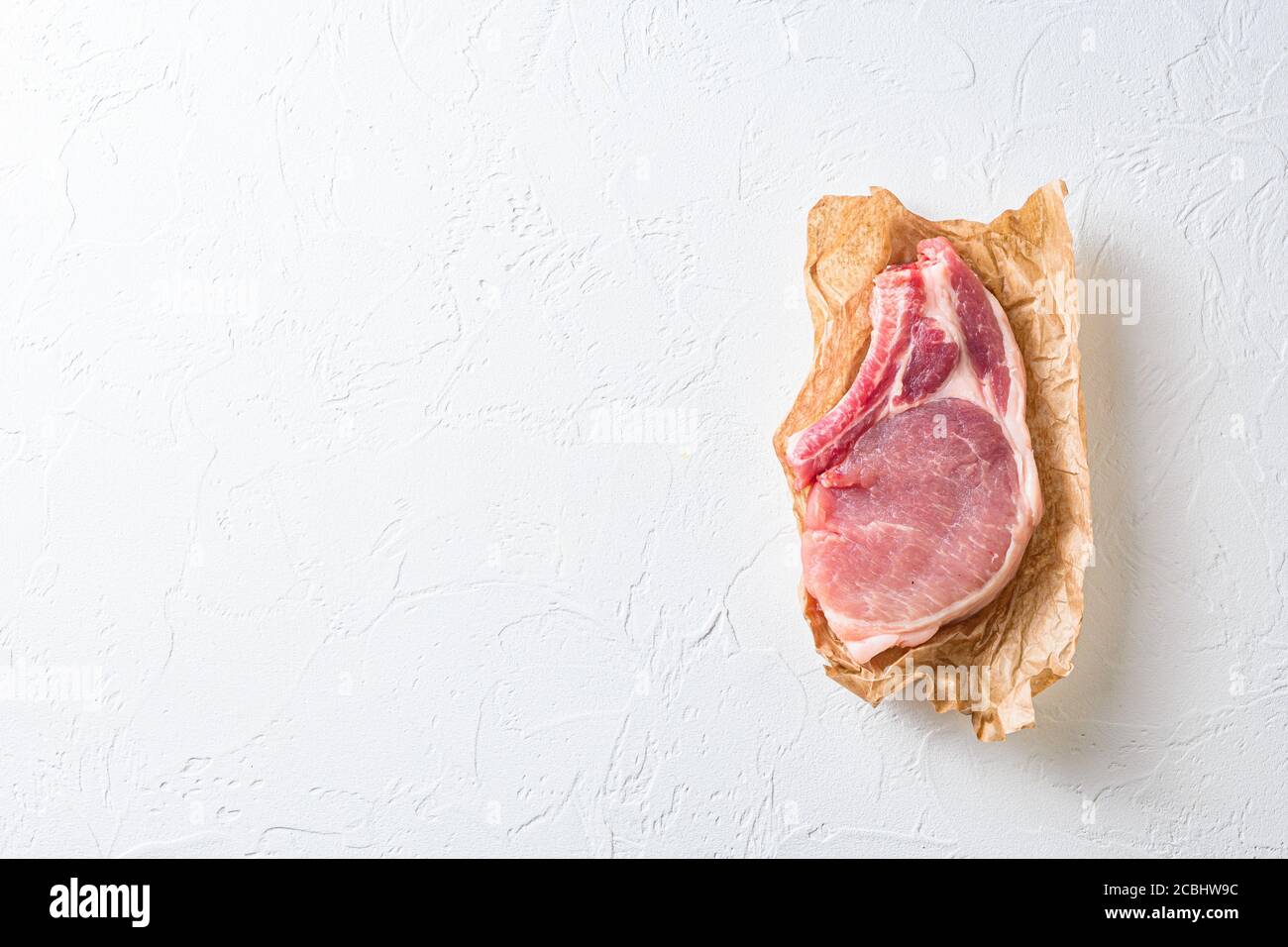 fresh bio raw meat organic cut pork on white stone table flatlay space ...