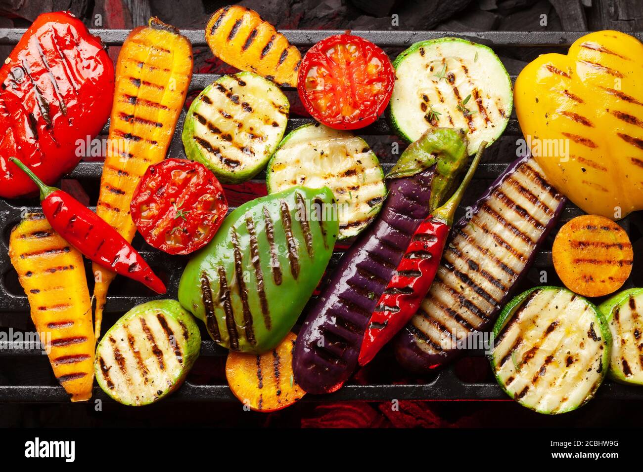 Grilled vegetables cooking on coal grill with spices and herbs. Top ...