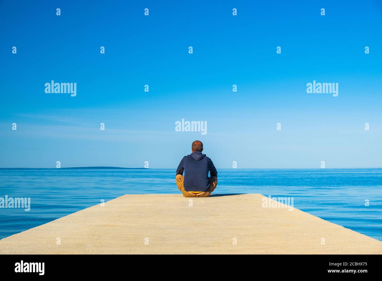 Man sitting on dock hi-res stock photography and images - Alamy