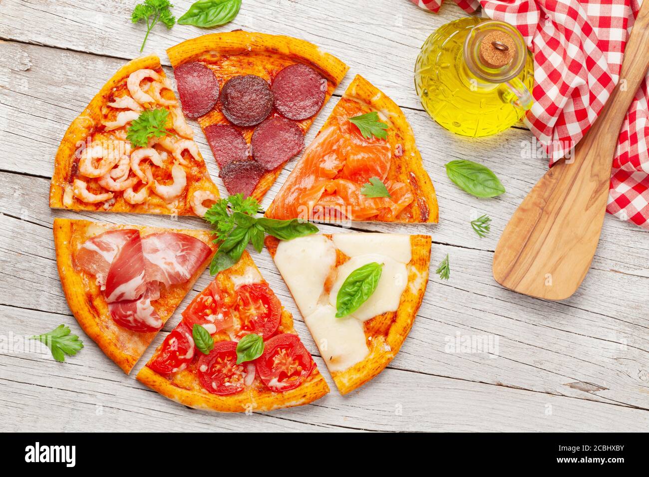 Tasty slices of different pizza with pepperoni, tomatoes, cheese and ...