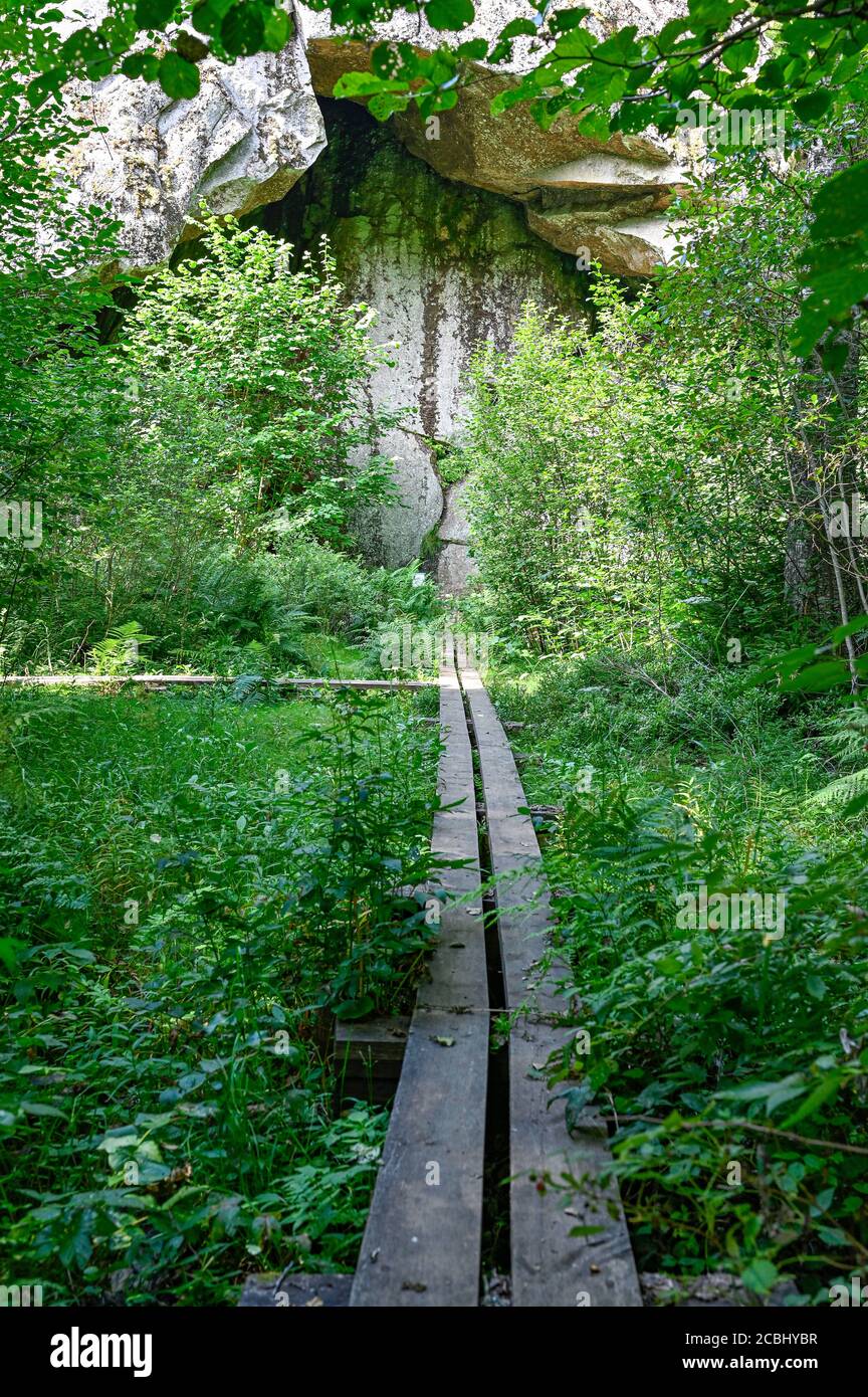 wooden footbridge leading to a big rock Stock Photo - Alamy