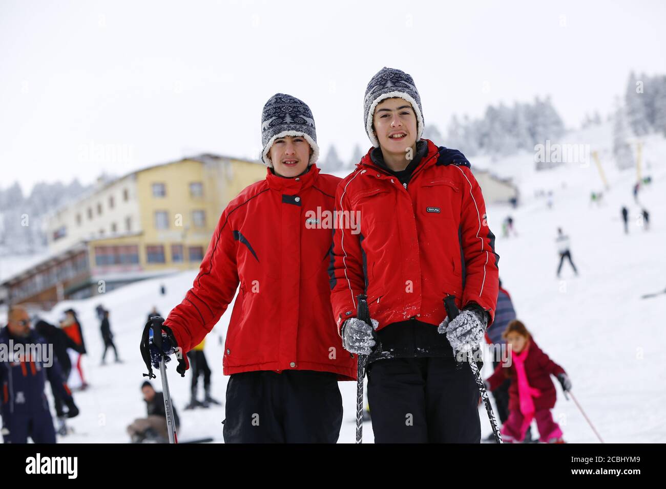 Portrait of happy twins in the snow Stock Photo - Alamy