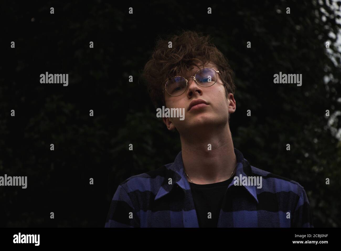 Swedish brown haired boy with glasses standing and looking into to ...