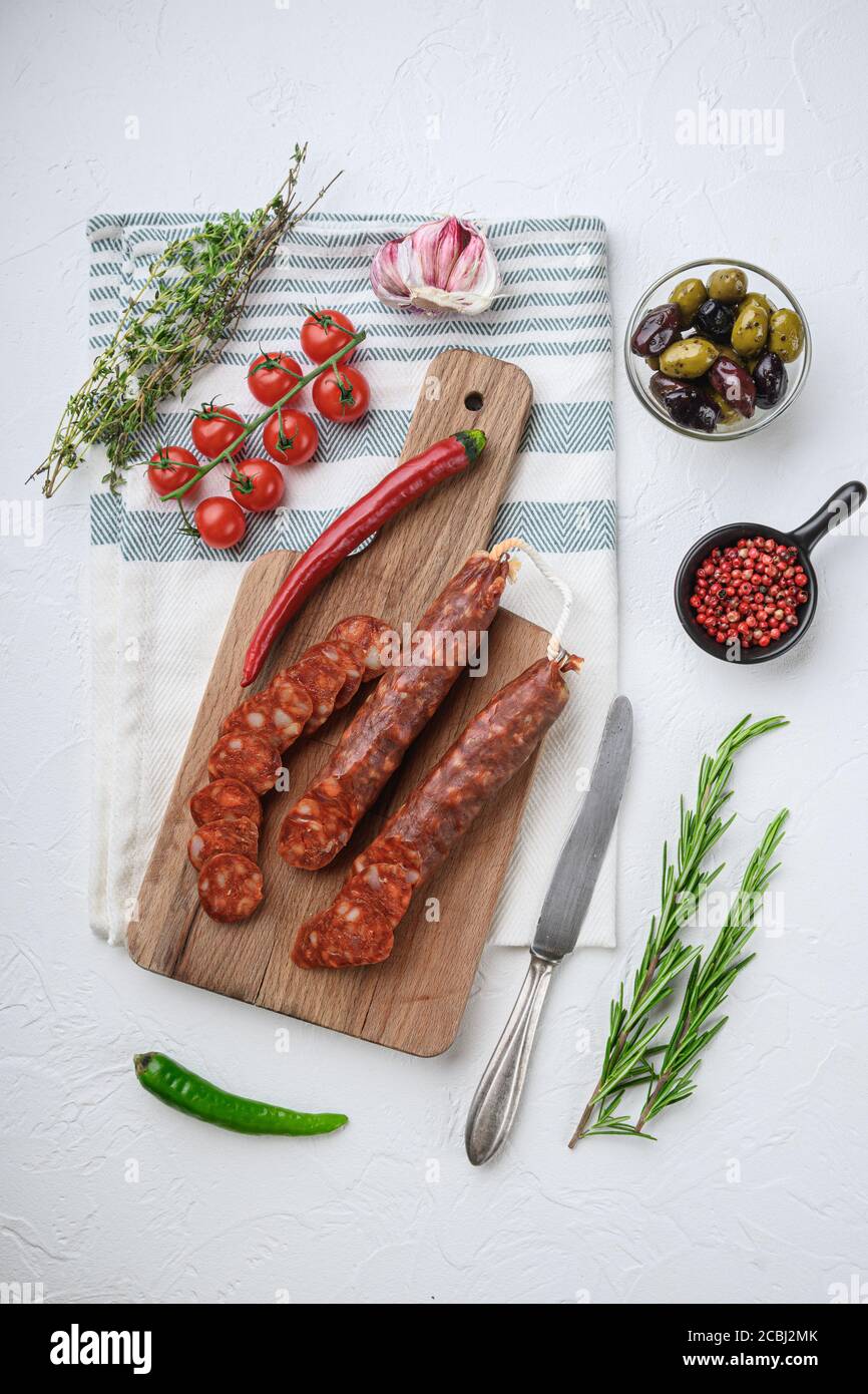 Traditional chorizo cuts with spices and ingredients on white surface ...
