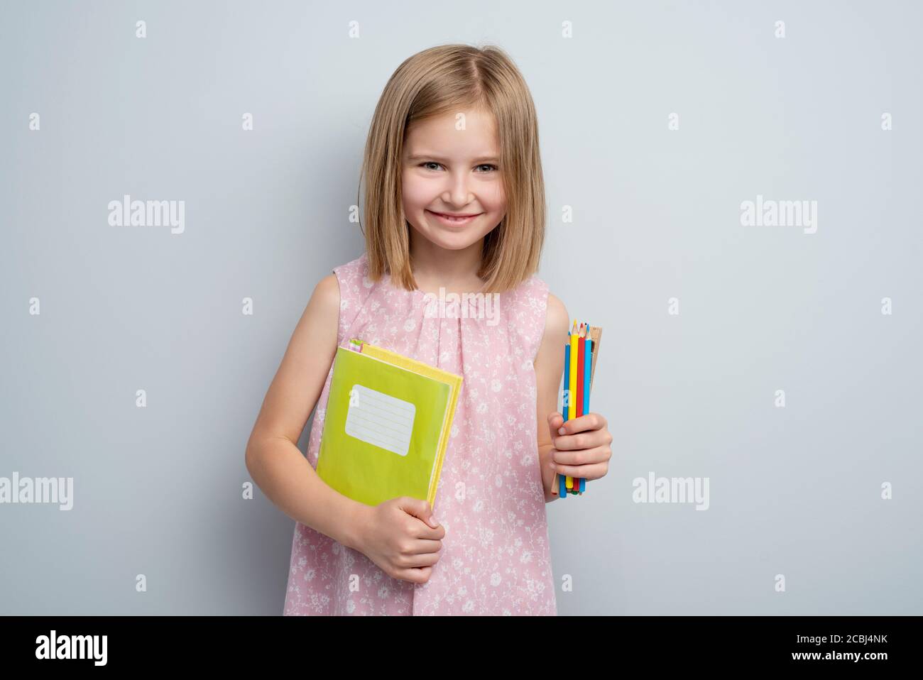 Little girl with school stationery supplies including textbook, ruler ...