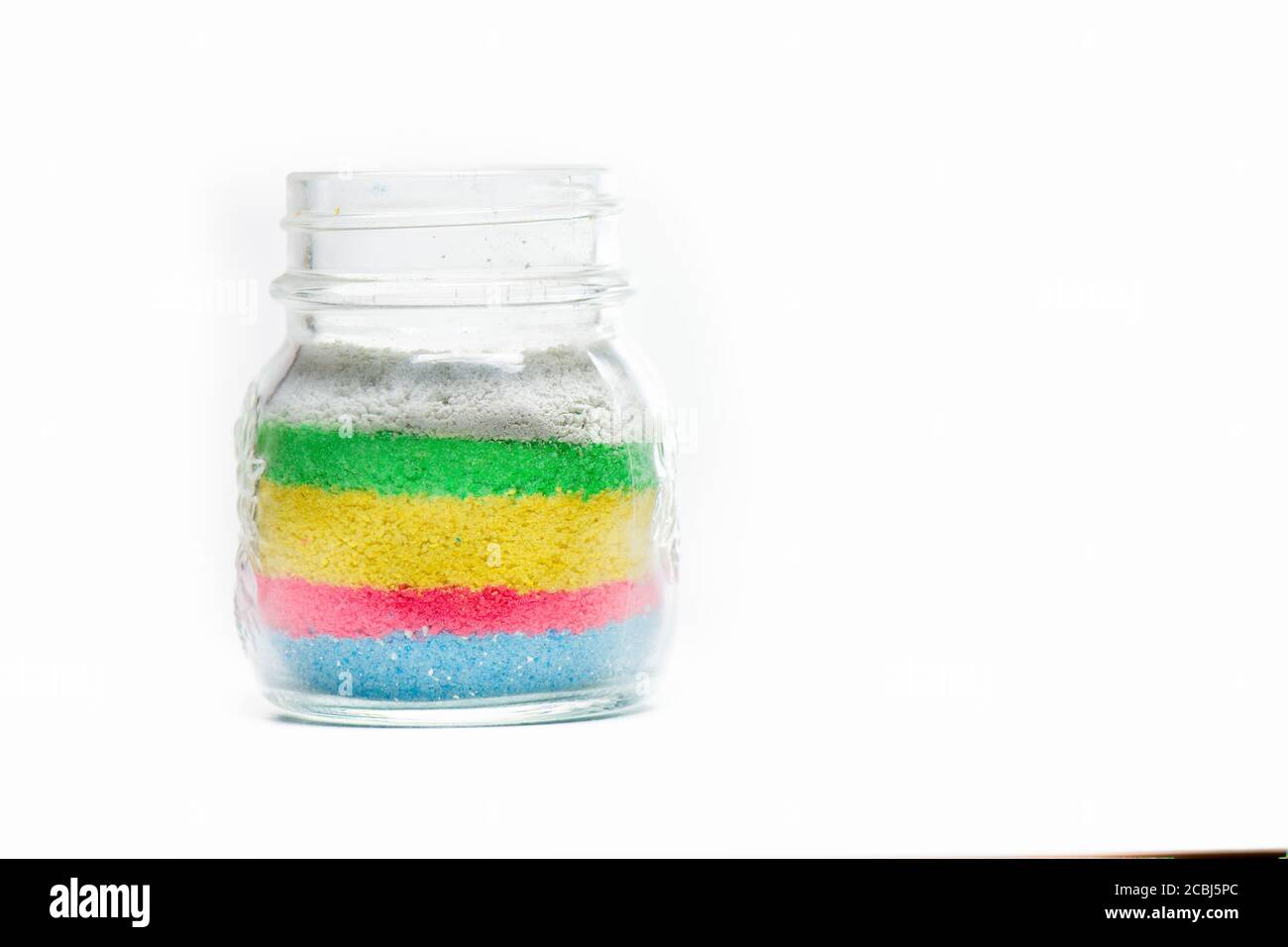 Glass jar with colored sand Stock Photo - Alamy